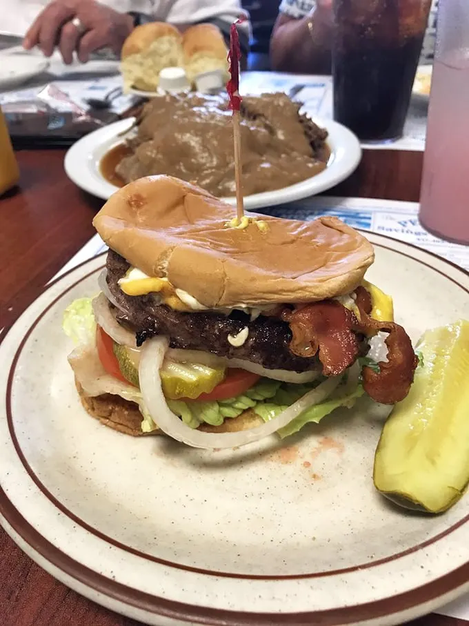 The legendary bison burger in all its glory – a towering masterpiece that makes regular burgers look like they're not even trying.