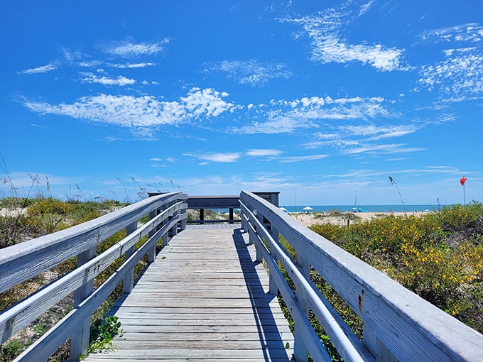 This wooden boardwalk isn't just a path to the beach – it's the runway for your grand entrance to paradise.