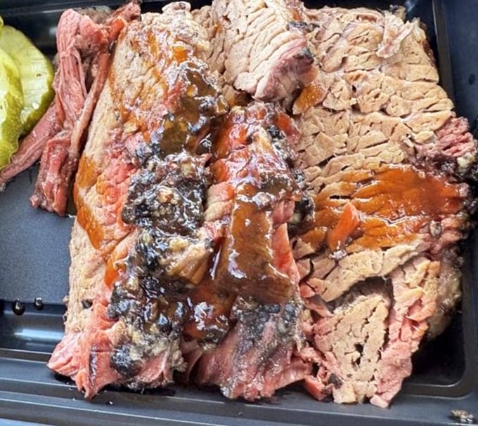 Behold the holy grail of barbecue – brisket with that perfect pink smoke ring and bark that makes meat lovers weak at the knees.