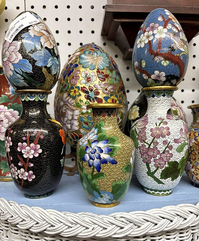 These intricate cloisonné vases and eggs aren't just decorative items—they're tiny masterpieces that survived decades to find their way onto this shelf, waiting for their next admirer.