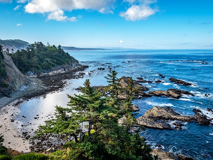 The Oregon coast showing off again – dramatic cliffs, azure waters, and enough natural beauty to make your social media followers green with envy.