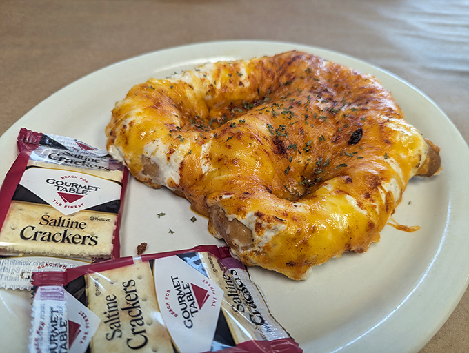 The legendary crab pretzel in all its glory—a soft, chewy base smothered in creamy crab dip and melted cheese. Resistance is futile.