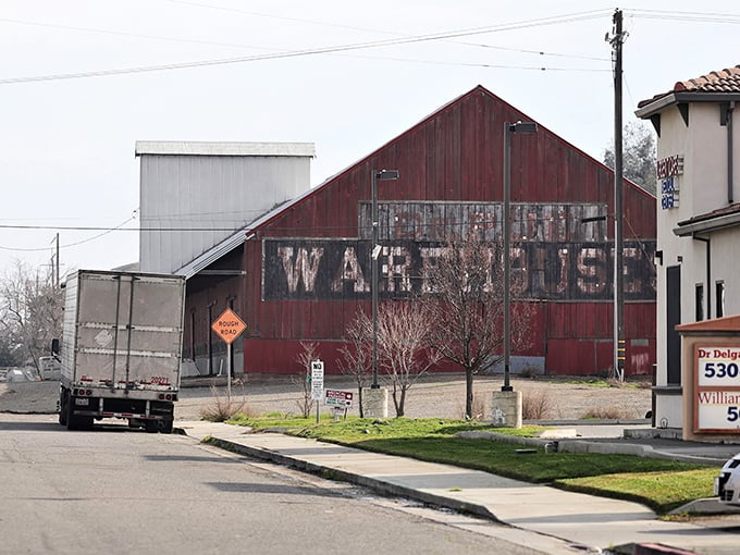 The faded "WAREHOUSE" lettering on this vintage barn isn't hipster décor—it's the real deal, a reminder of Williams' authentic agricultural roots.