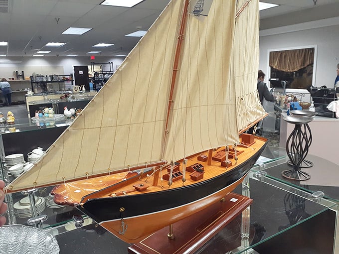 This model sailboat isn't just decorative—it's someone's forgotten maritime dream waiting for your living room to become its harbor.