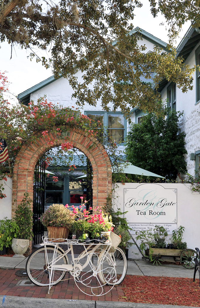 The Garden Gate Tea Room welcomes visitors through a flower-draped brick archway. Even non-tea drinkers will feel their pinkies involuntarily rising at the sight.
