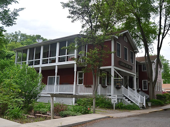 The Green Tree Inn offers more than just a bed for the night – it's a time machine disguised as a charming B&B with a porch that practically demands you sit a spell.