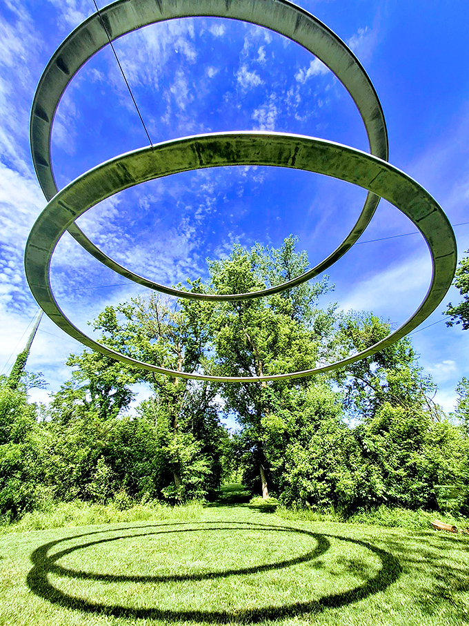 Look up and question everything. These suspended metal rings transform with changing light, creating a cosmic portal right in the heart of Indiana.