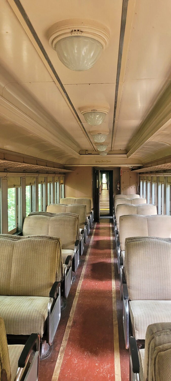Step inside history with these meticulously preserved vintage train car interiors – where the elegant ceiling fixtures and plush seating whisper stories of rail travel's golden age.