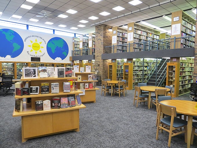 The local library isn't just about books—it's a community living room where worlds collide under those globe murals and wooden shelves.