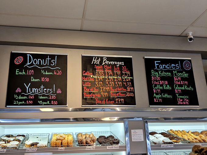 The chalkboard menu at Yum Yum speaks a universal language: "Donuts!" "Yumsters!" "Fancies!" – poetry that needs no translation.