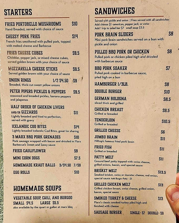 This isn't just a menu—it's a culinary time capsule. Where else can you find brain sandwiches sharing space with kraut balls in 2023?