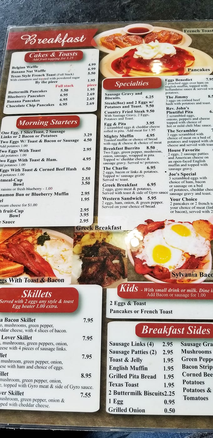 The breakfast menu—a laminated masterpiece where every option feels like it was personally selected by your grandmother who wants to fatten you up.