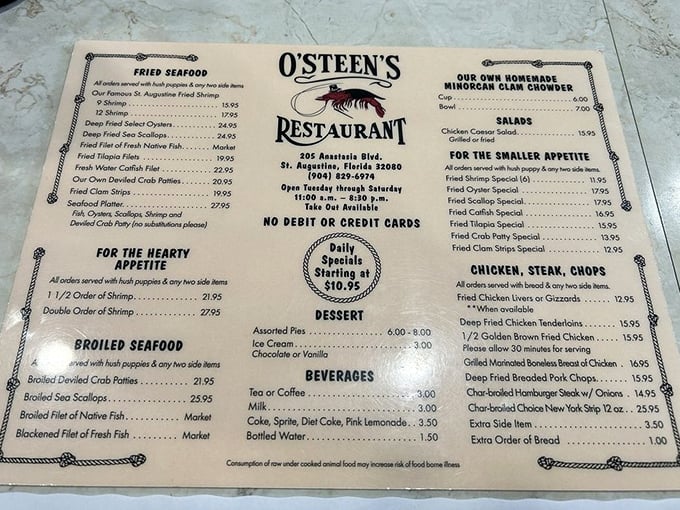 A menu that hasn't surrendered to QR code tyranny – just honest seafood offerings printed on actual paper like civilization intended.