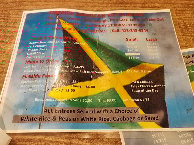 This laminated menu might not win design awards, but it's a treasure map to flavor country—complete with Jamaican flag colors guiding your journey.