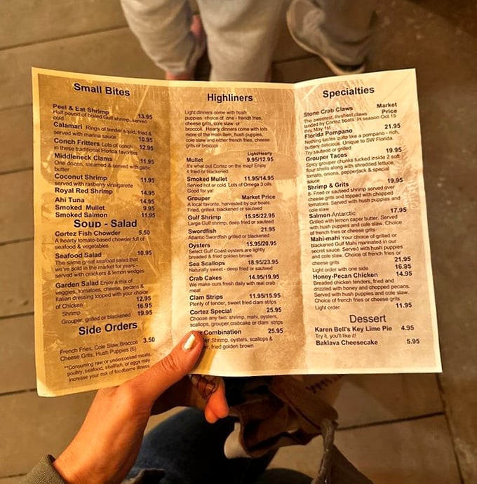 A menu worn by countless hungry hands. Simple categories, straightforward preparations, and the promise of "market price" tell you everything's fresh off the boat.