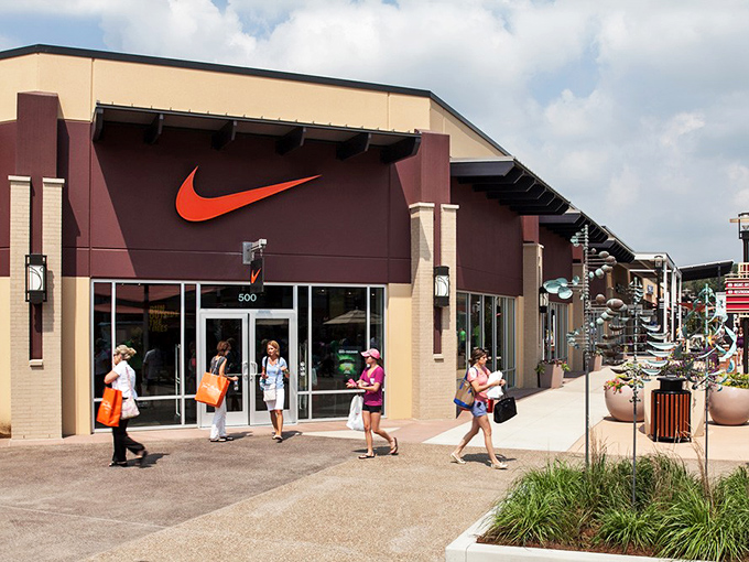 The iconic swoosh beckons shoppers like a retail lighthouse. Nike's storefront promises athletic inspiration, even if your only marathon is from store to store.