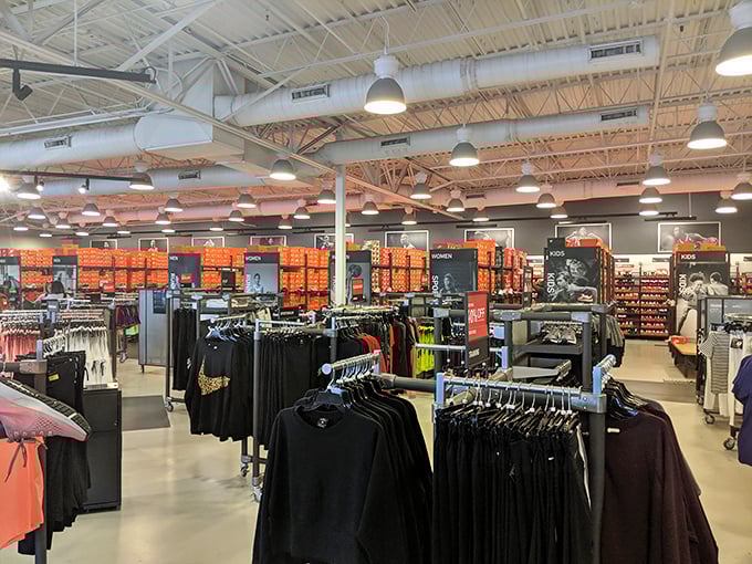 Inside Nike's outlet paradise, where orange boxes stack toward heaven and the promise of running faster (or at least looking good trying) comes at 40% off retail.