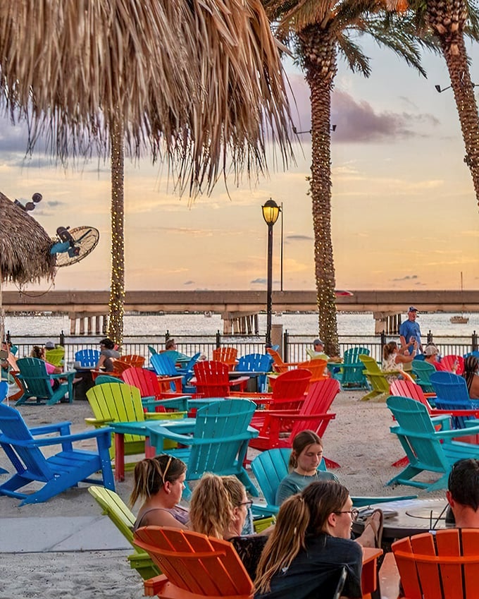 Rainbow-colored Adirondack chairs at sunset – where Florida's happy hour means nature puts on a show while you sip something cool and contemplate absolutely nothing.
