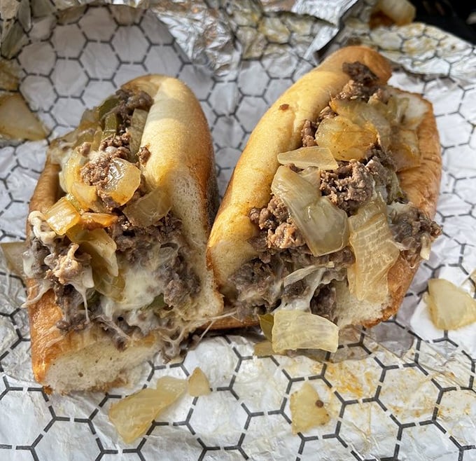Behold the star of the show – thinly chopped ribeye, melted cheese, and caramelized onions nestled in a perfect roll. Poetry in sandwich form.