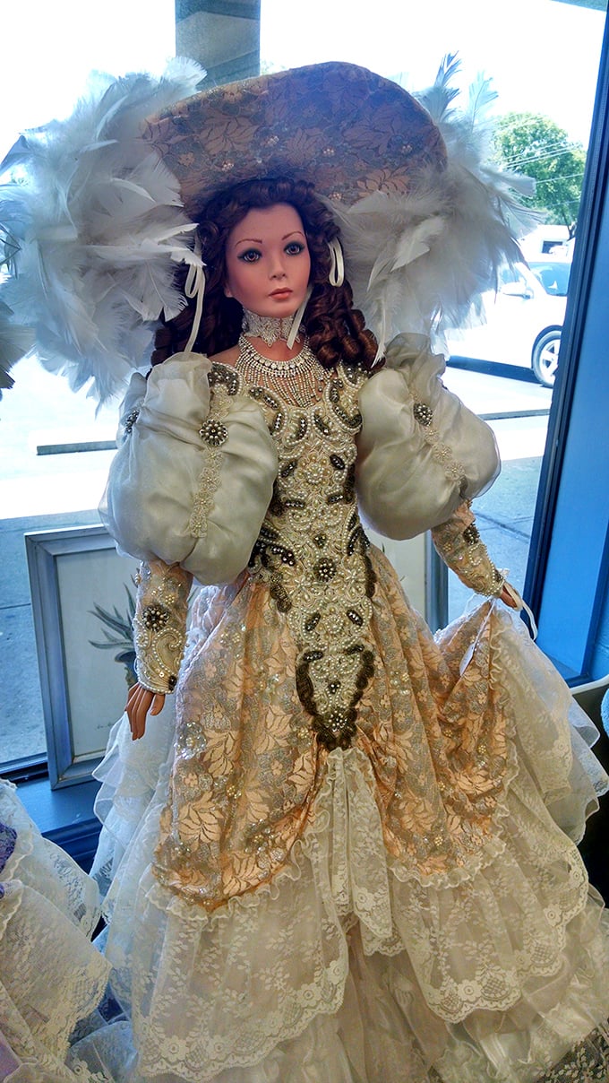 Not just any doll, but a regal time-traveler from another era. That feathered hat alone probably has more stories than most people's entire wardrobes.