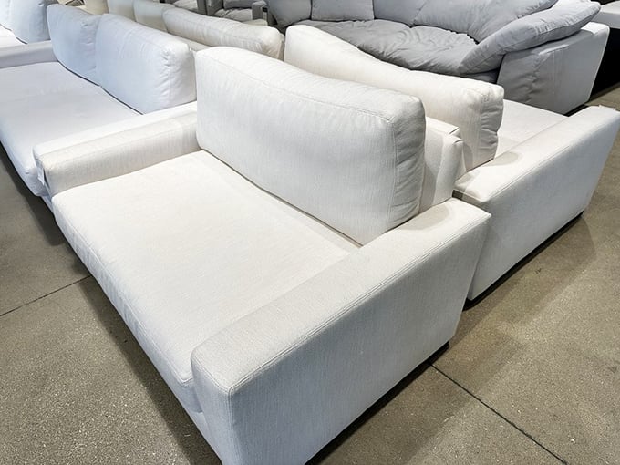 These pristine white sofas aren't just for show—they're strategically placed relationship savers for weary shopping companions who've hit their retail limit.
