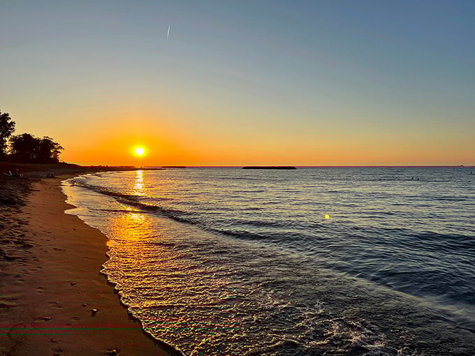 Nature's own light show paints the sky in impossible oranges and pinks, proving that Lake Erie sunsets give California's coastal views a run for their money.