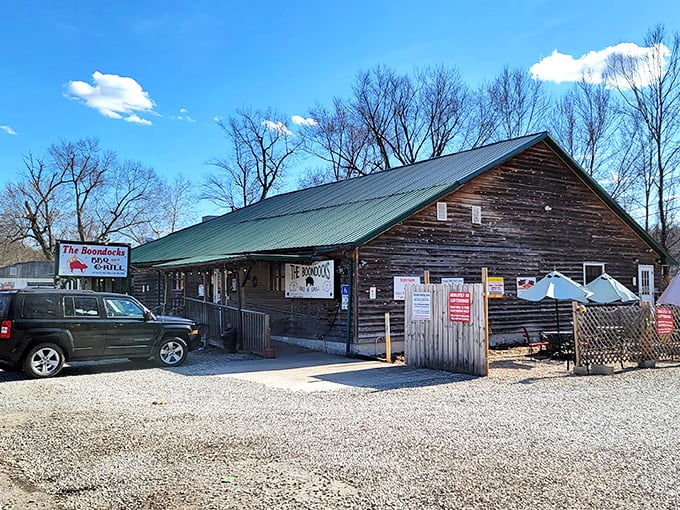 The Boondocks BBQ & Grill's rustic wooden exterior promises the kind of authentic smokehouse experience that makes you want to loosen your belt before you even order.