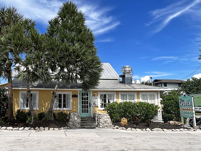 The Porch Restaurant's sunny yellow facade is like Florida sunshine in architectural form – inviting you in for a taste of island life.