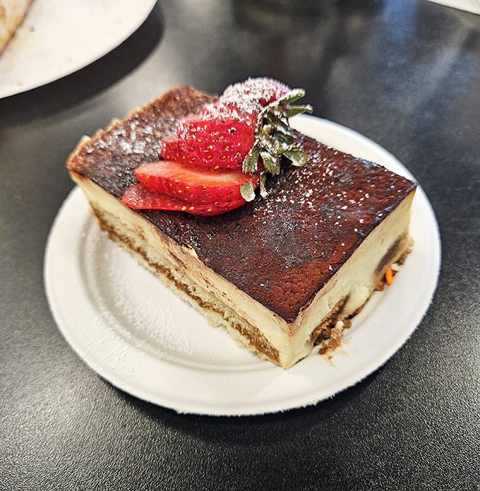 This tiramisu isn't just dessert, it's an edible masterpiece. That strawberry on top isn't garnish—it's the crown jewel of a flavor kingdom.
