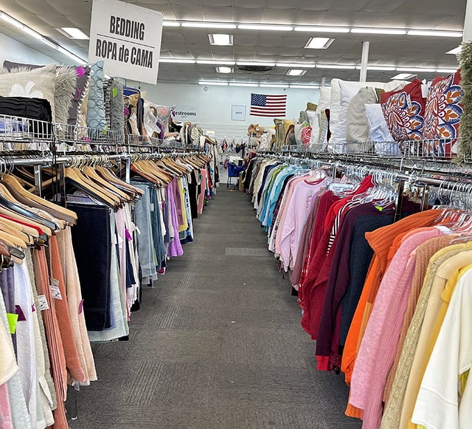 Not just rows of clothing—these are corridors of possibility, where yesterday's fashion finds tomorrow's admirers. Note the bilingual signage welcoming all bargain hunters.