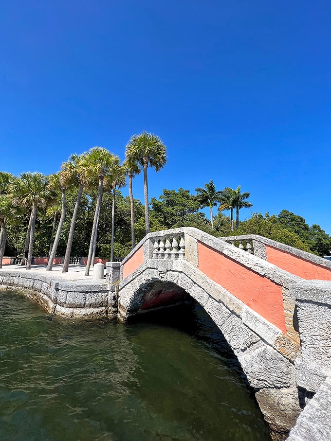 This isn't just any bridge—it's a coral-stone catwalk where palm trees stand guard over Biscayne Bay's shimmering waters.