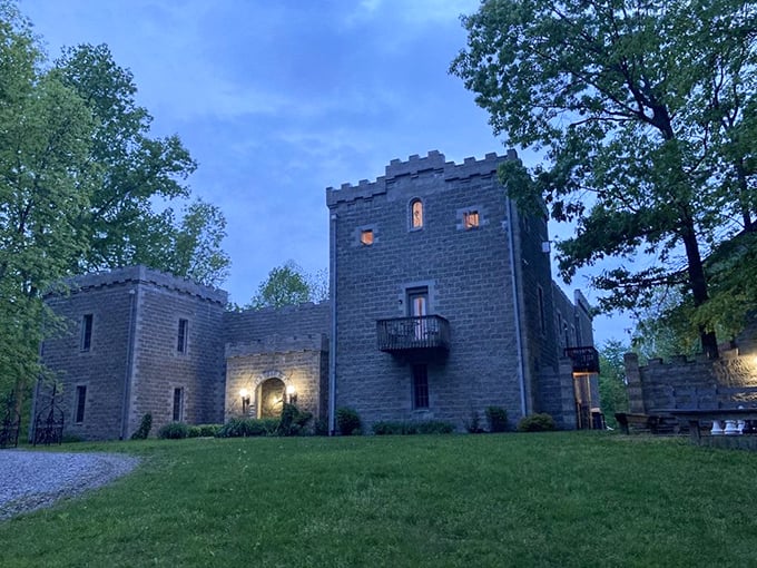 As dusk settles over Ravenwood Castle, the illuminated windows hint at cozy chambers within—medieval on the outside, thankfully modern plumbing on the inside.