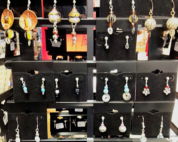Handcrafted earrings catch the light and imagination – each pair waiting to become someone's perfect conversation starter.