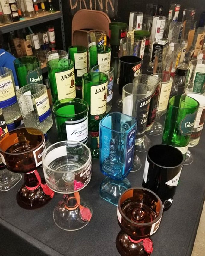 Upcycled liquor bottles transformed into colorful drinking glasses—proof that one person's recycling is another's dining room conversation piece.