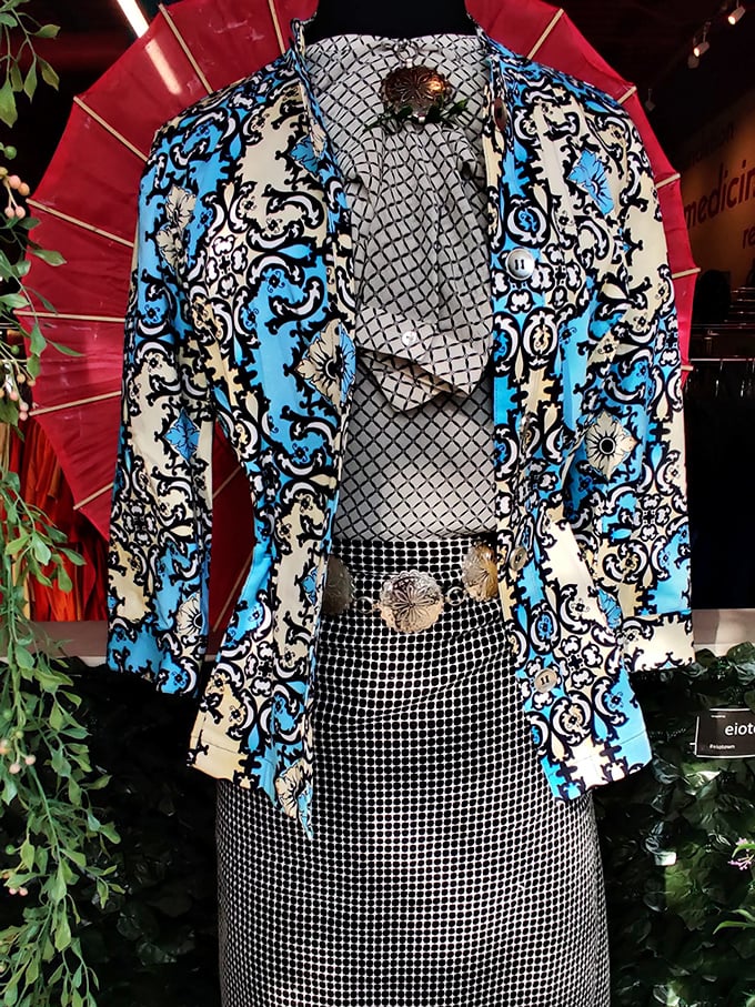 This blue patterned blazer isn't just clothing—it's a conversation starter waiting to happen. Paired with that checkered skirt? Pure thrifting magic.