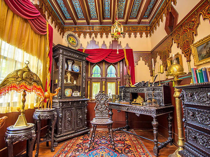 Step into this study and you've time-traveled to Victorian opulence, where every carved surface tells a story and that rug definitely ties the room together.