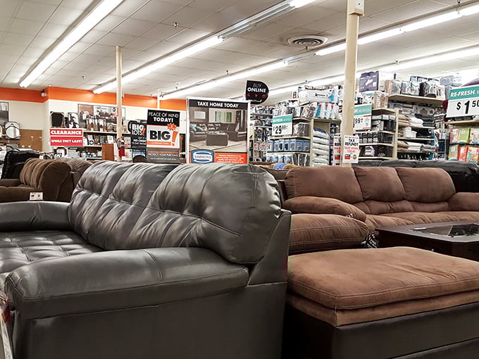 The furniture section showcases sofas that won't require a second mortgage – comfort meets affordability in this leather and microfiber showdown.