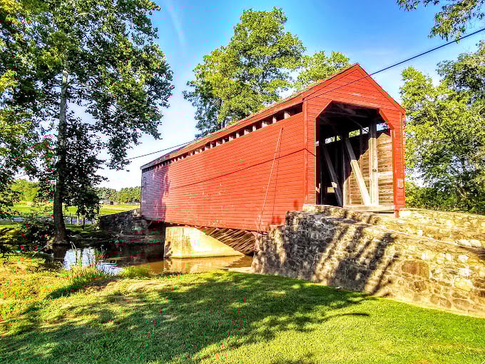 The bridge's vibrant red exterior isn't just pretty—it's practical. This protective coating has helped preserve the wooden structure through countless seasons.