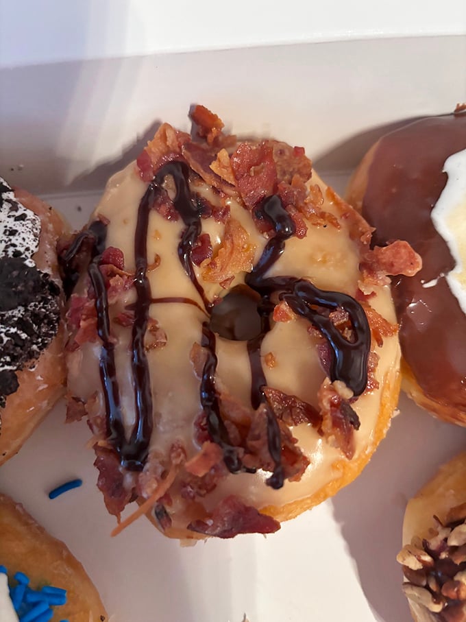 The maple bacon donut—where breakfast's greatest hits collaborate in perfect harmony. Sweet maple glaze meets savory bacon in this morning masterpiece.
