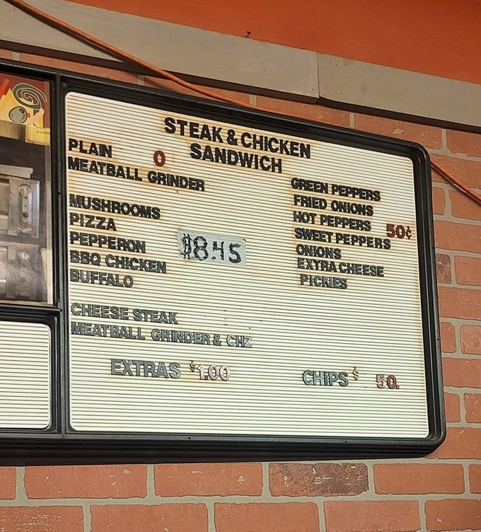 A menu board that's refreshingly straightforward—no truffle oil or farm-to-table buzzwords, just honest pizza and sandwich classics at neighborhood prices.