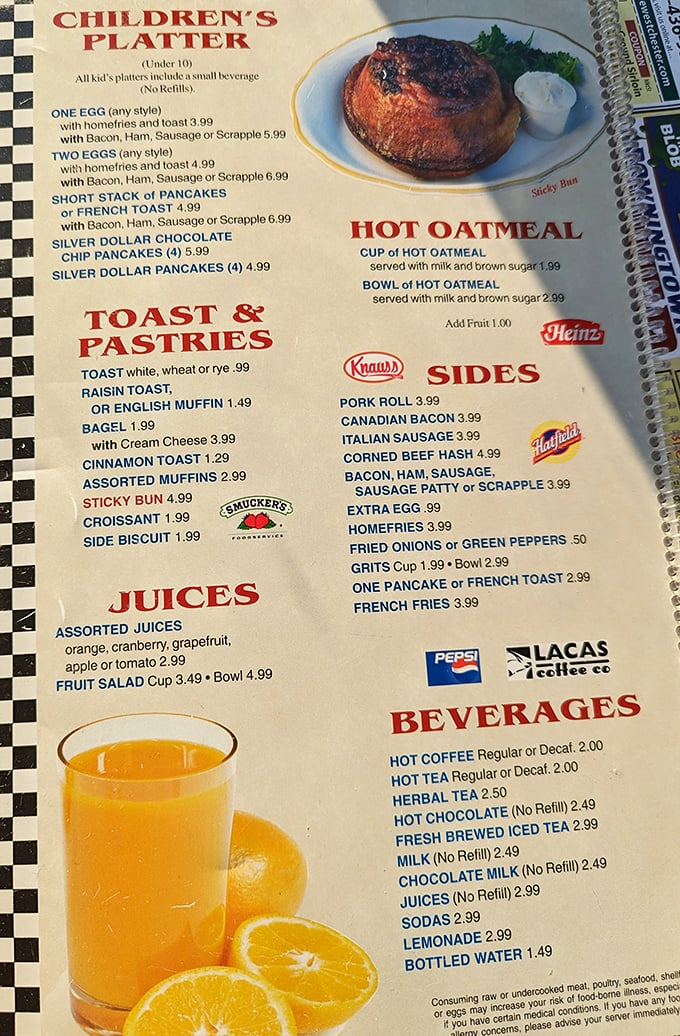 The menu—a spiral-bound epic of breakfast possibilities that makes choosing just one item feel like Sophie's Choice for the hungry.