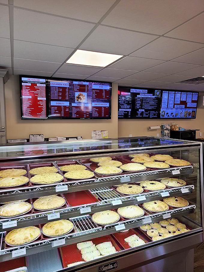 The digital menu boards showcase an impressive lineup that goes far beyond the name – pizza, pies, and everything nice.