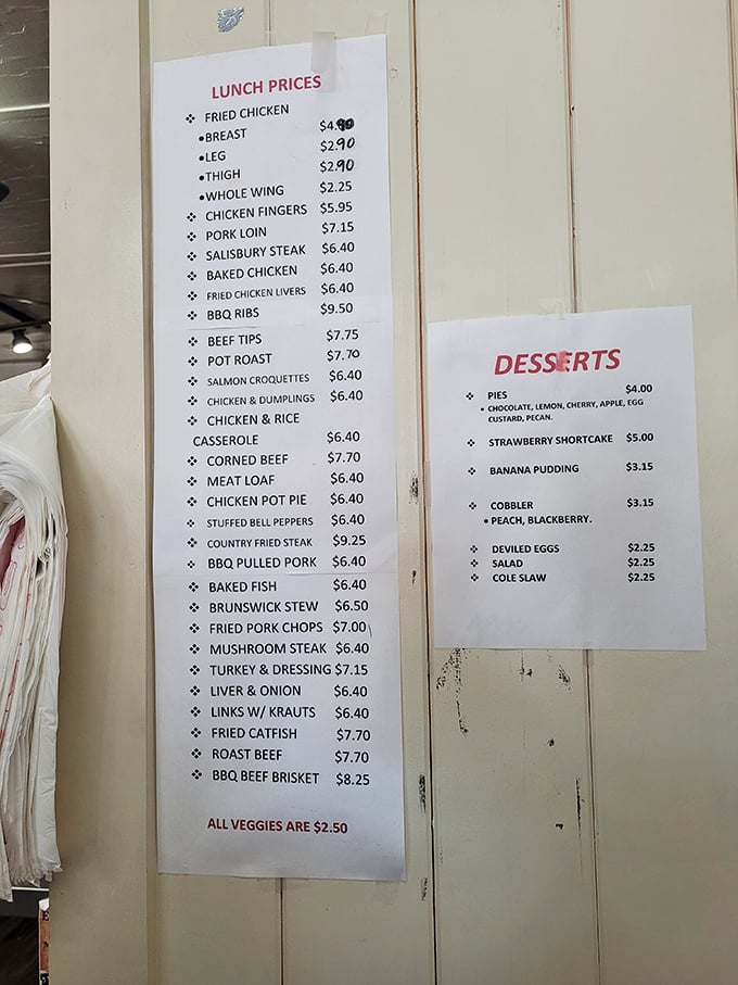 The menu board—a sacred text of Southern cuisine where mac and cheese rightfully claims its place as a vegetable.