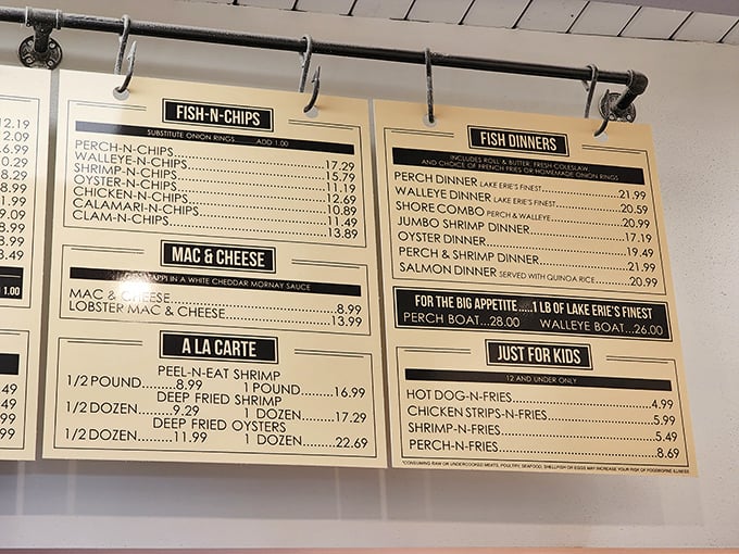 The wall-mounted menu board—a treasure map where X marks the spot for Lake Erie's bounty, from perch to walleye to those legendary boats.