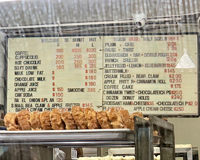 The menu board at Donut Hut is like a treasure map to happiness. No fancy fonts or pretentious descriptions—just straightforward paths to satisfaction.