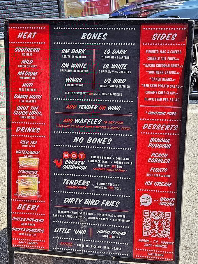 The menu board reads like a dare wrapped in Southern hospitality – choose your heat level wisely, friends.