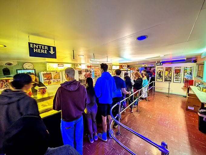 The concession line shuffle—a time-honored intermission ritual where strangers become temporary friends united by the quest for buttered popcorn.