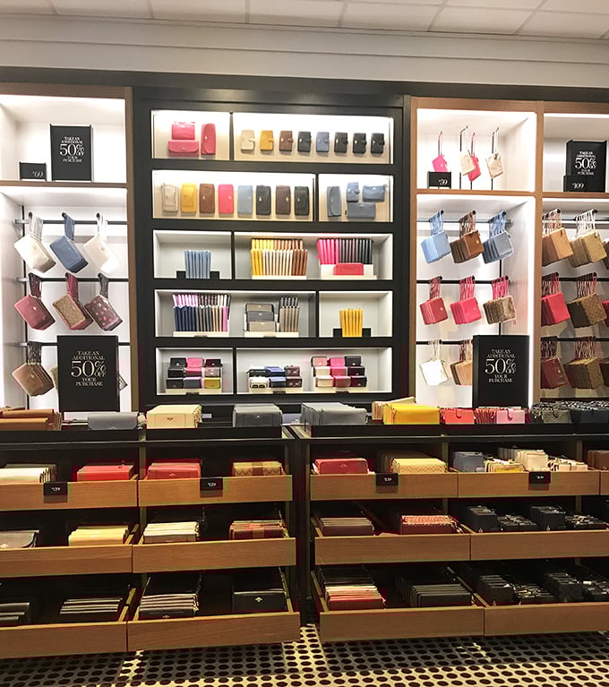 Wallet wonderland! A rainbow of leather accessories arranged with the precision of a jewelry store and the prices of... well, an outlet mall.