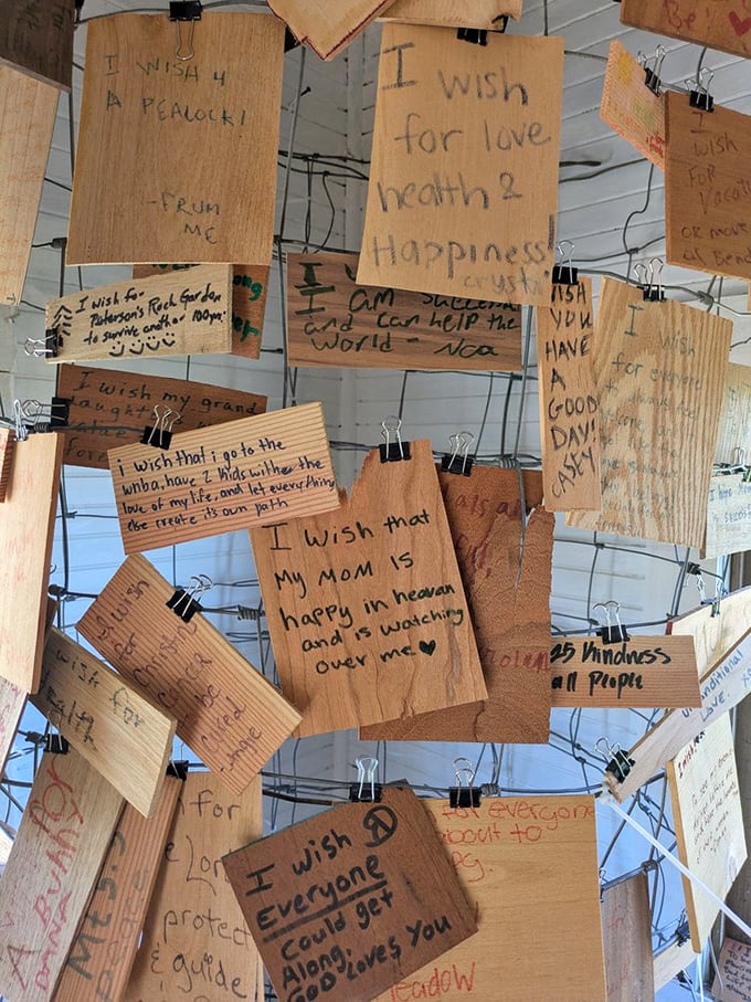 Dreams hanging by binder clips—the wish house displays heartfelt hopes from "I wish for a peacock" to touching tributes to loved ones watching from above.
