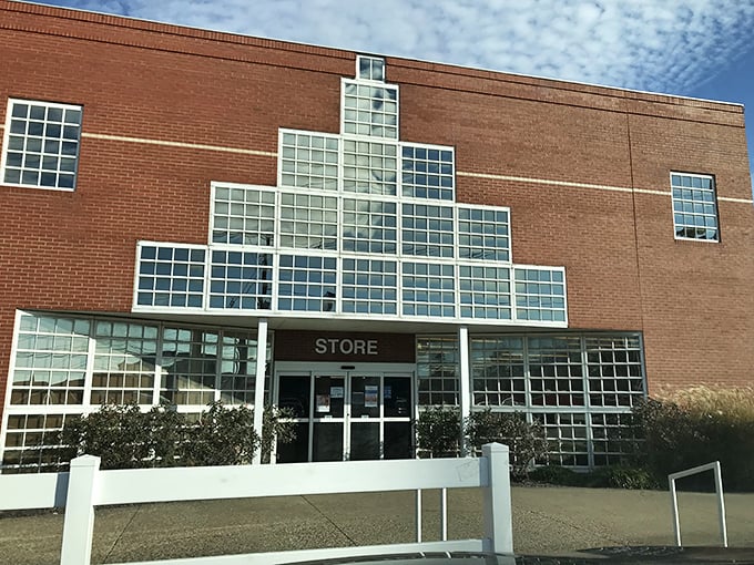 Goodwill Outlet's distinctive glass-block entrance catches the morning light. Architectural throwback meets bargain hunter's paradise.